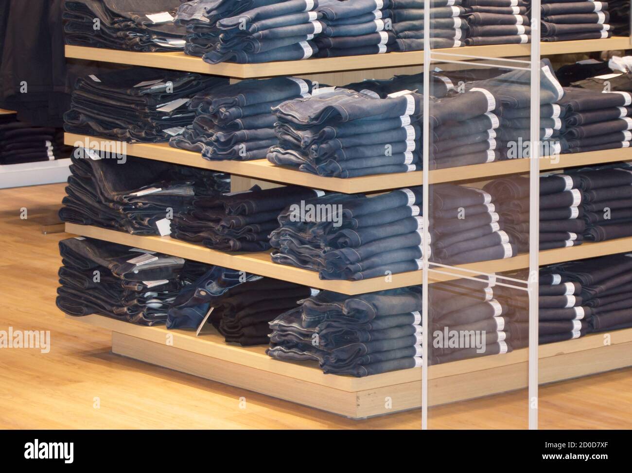 Jeans are stacked on the counter in a clothing store Stock Photo - Alamy