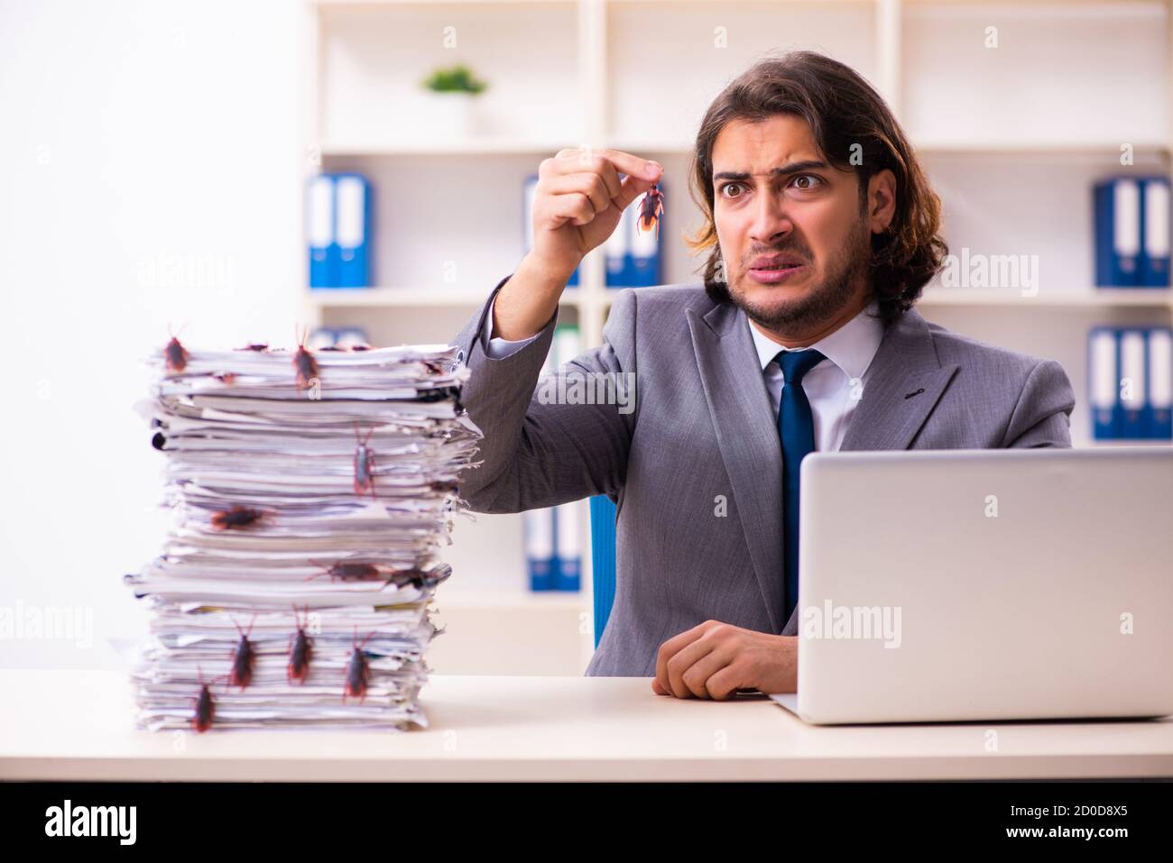 Young employee and too many cockroaches in the office Stock Photo - Alamy