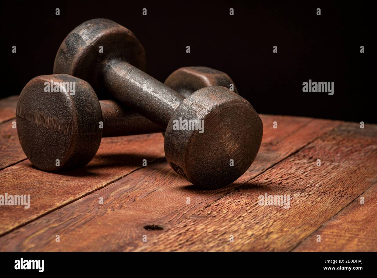 vintage rusty iron dumbbells on grained barn wood background - fitness ...