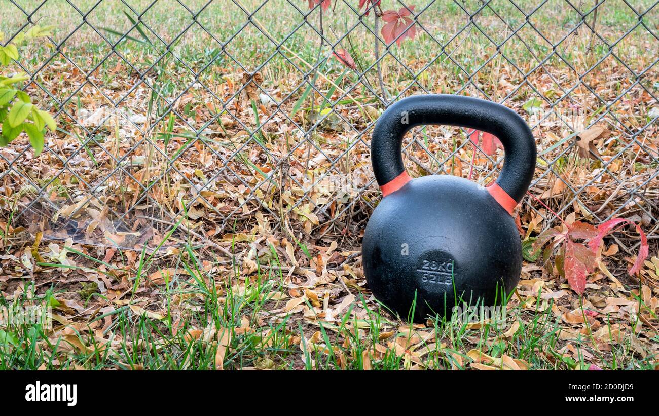 iron kettlebell in a backyard - outdoor fitness concept Stock Photo - Alamy