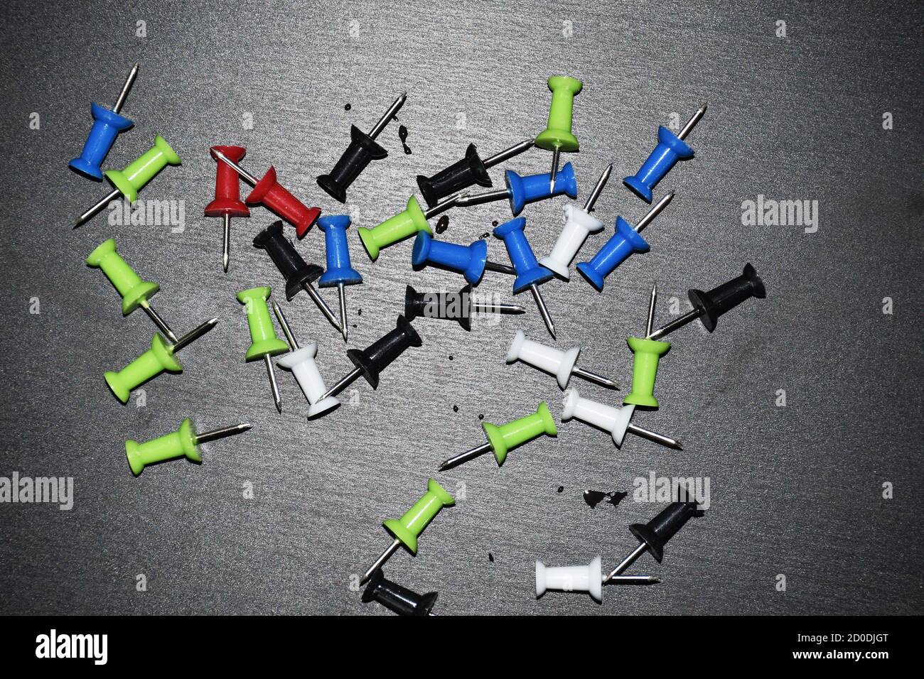 colorful punch pins drawing pins on black background Stock Photo - Alamy