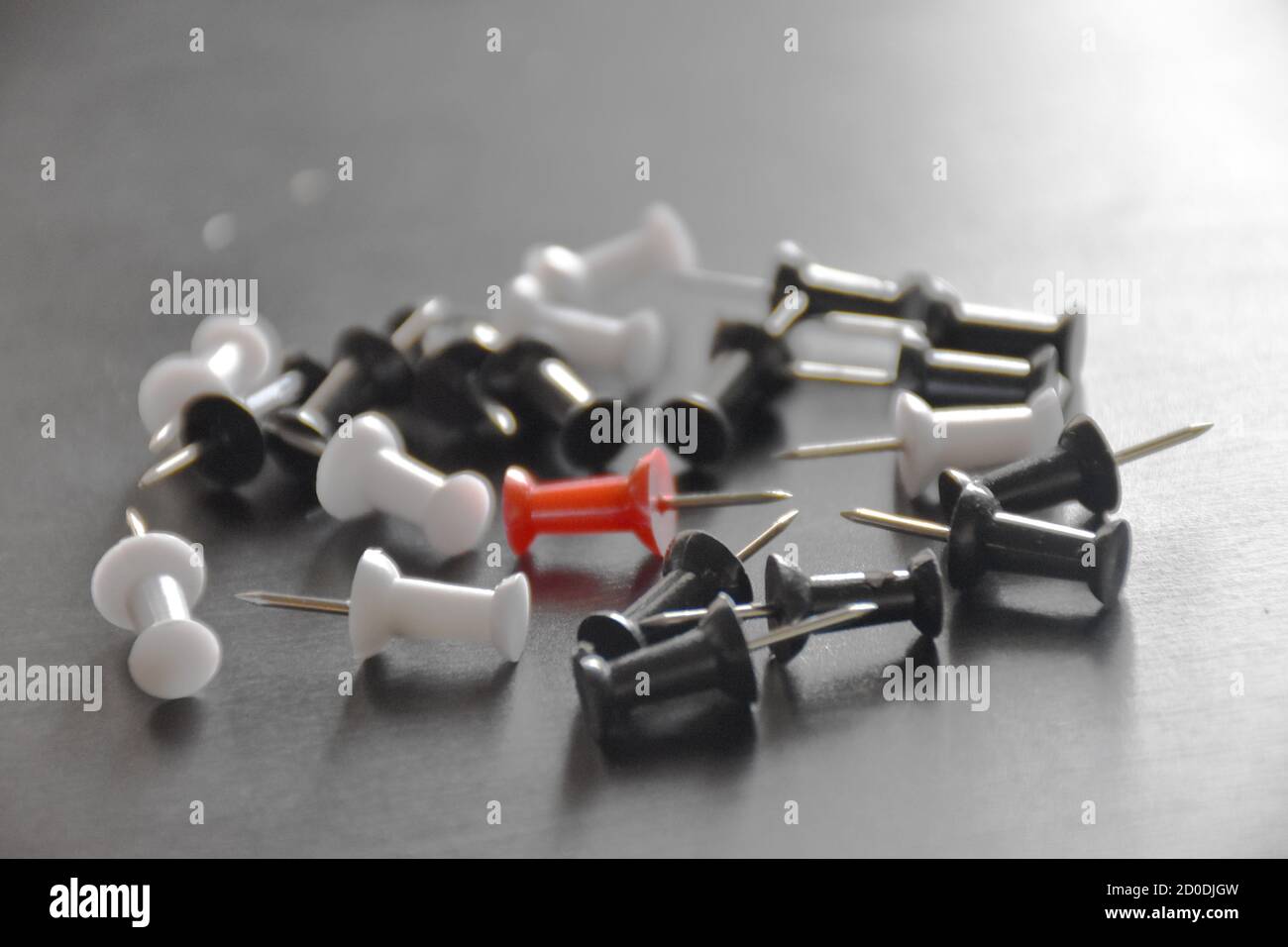 colorful punch pins drawing pins on black background Stock Photo - Alamy