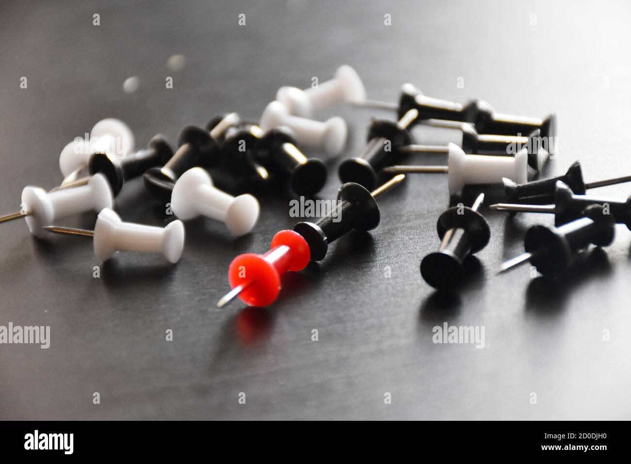 colorful punch pins drawing pins on black background Stock Photo - Alamy