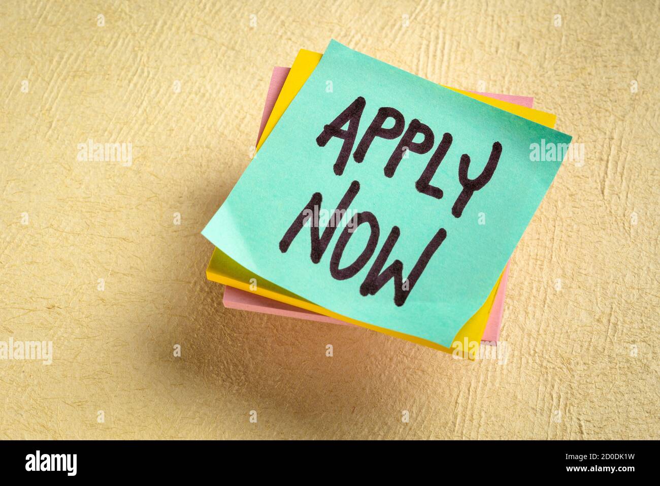 Apply now - handwriting on a reminder note, business marketing concept ...
