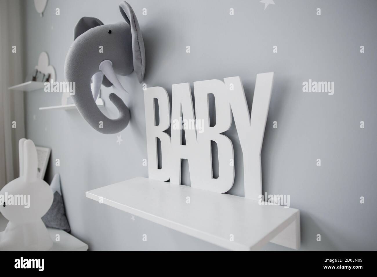 gray inscription baby on the wall in room Stock Photo - Alamy