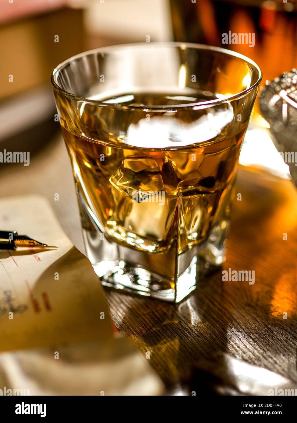 Glass of whisky, books and diary late at night Stock Photo - Alamy