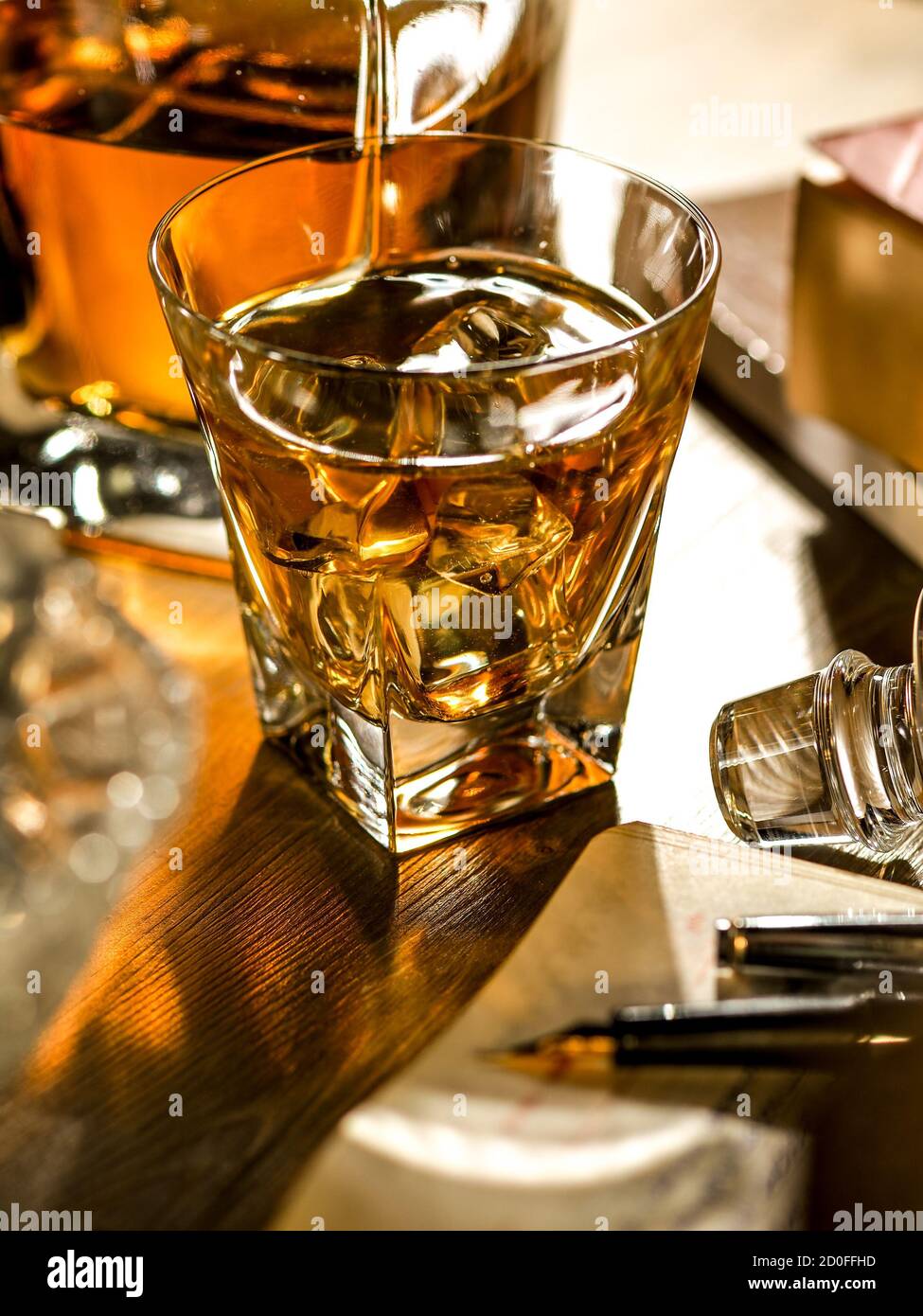 Glass of whisky, books and diary late at night Stock Photo - Alamy