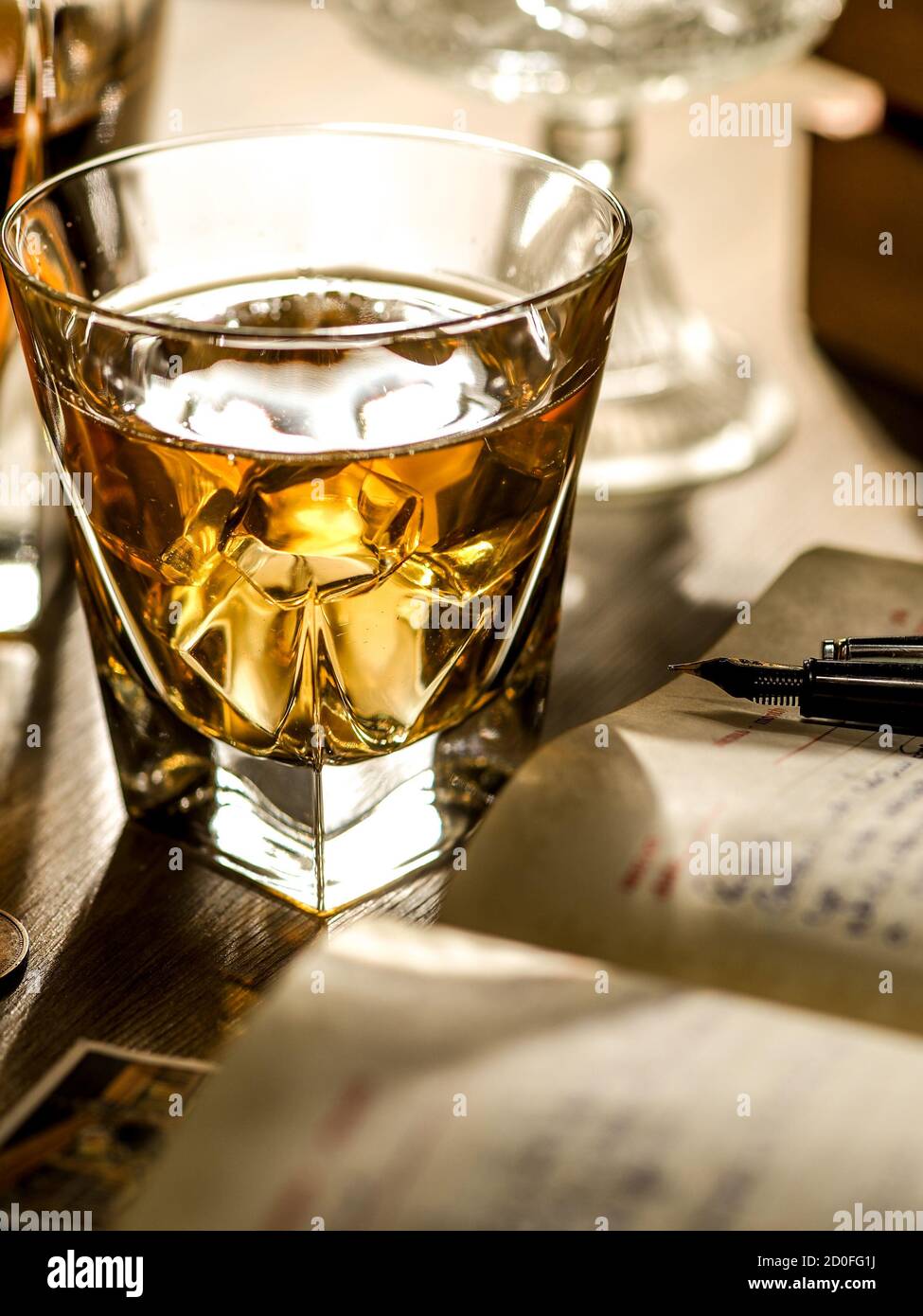 Glass of whisky, books and diary late at night Stock Photo - Alamy