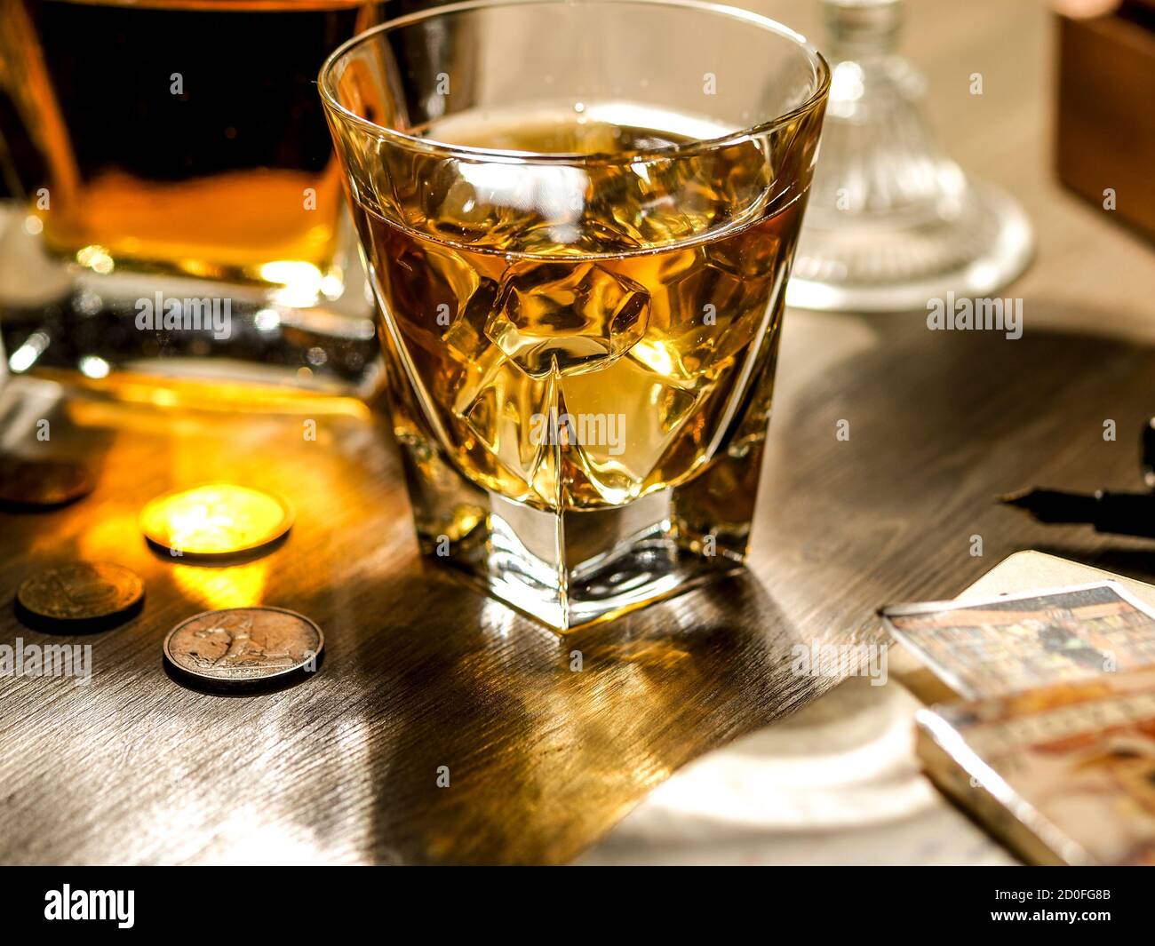 Glass of whisky, books and diary late at night Stock Photo - Alamy