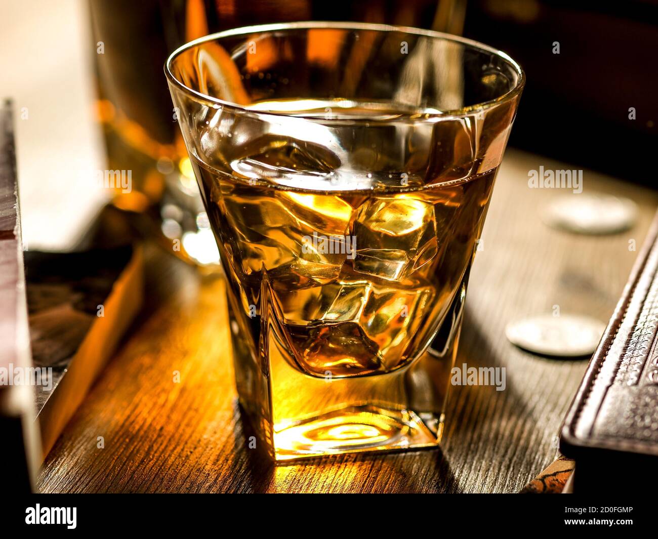 Glass of whisky, books and diary late at night Stock Photo - Alamy
