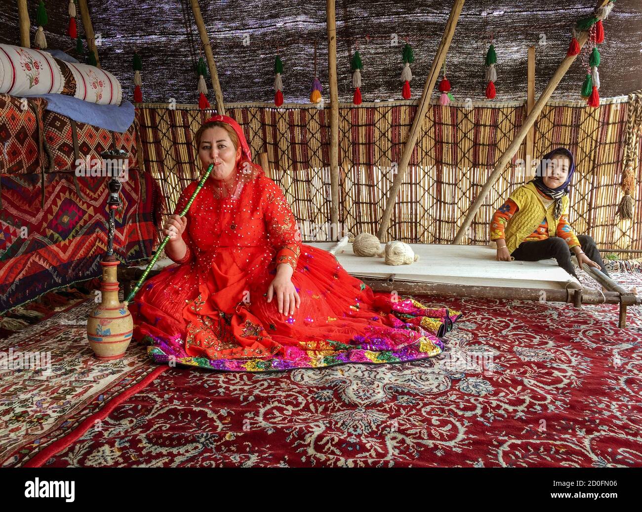Shiraz, Iran - 2019-04-09 - Qashgal woman smokes water pipe hookah in ...