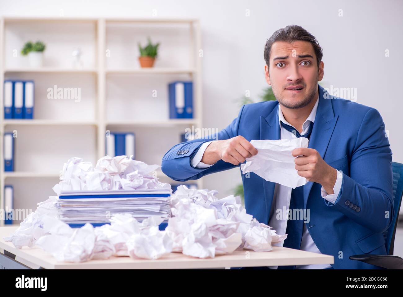 Businessman rejecting ideas with lots of papers Stock Photo - Alamy
