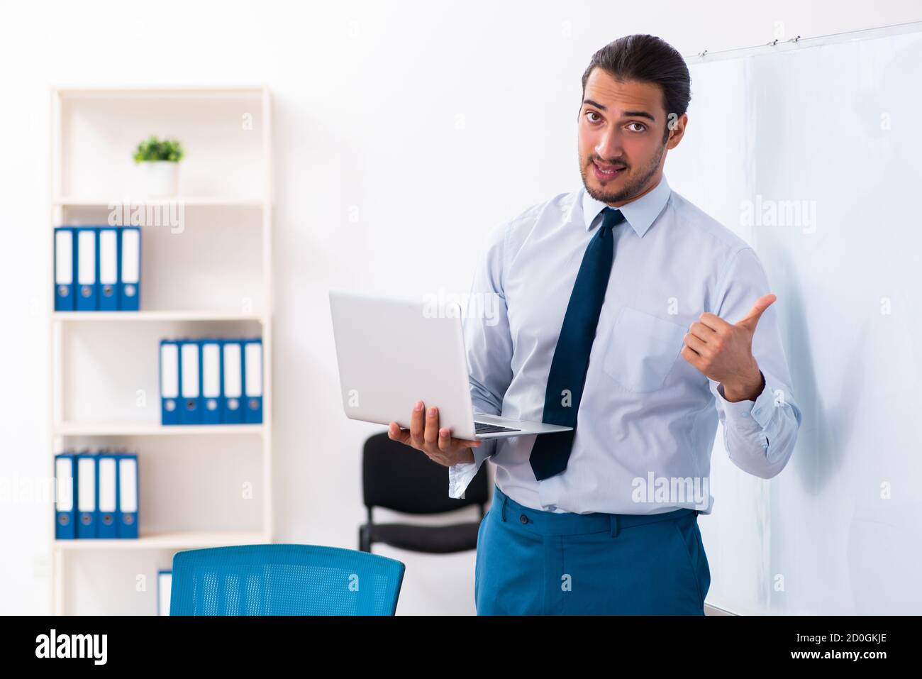 Young employee in business presentation concept Stock Photo - Alamy