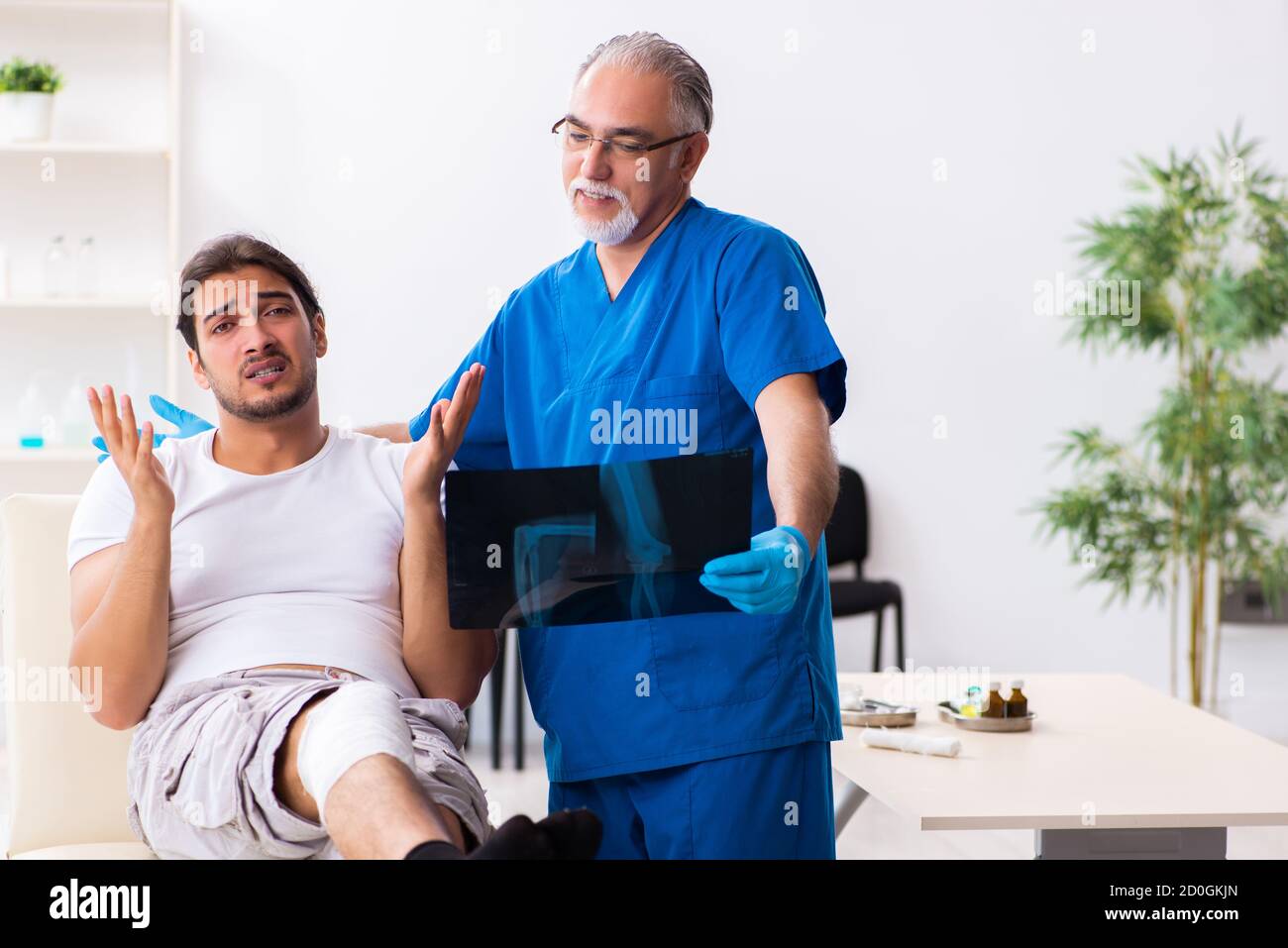 Leg injured man visiting doctor in first aid concept Stock Photo - Alamy