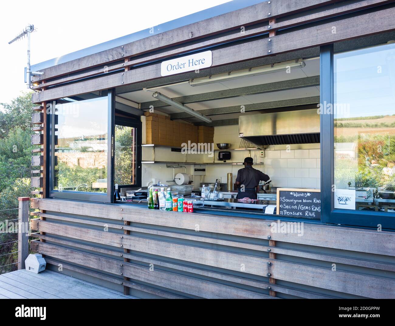 food kiosk with open window and chef cooking in the kitchen at a casual ...