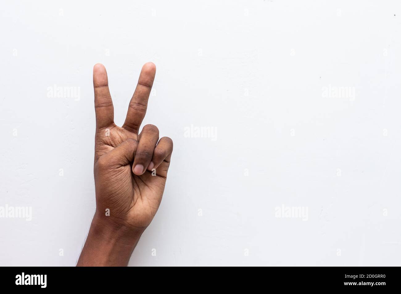 Boy hand showing number two gesture symbol isolated on white background ...
