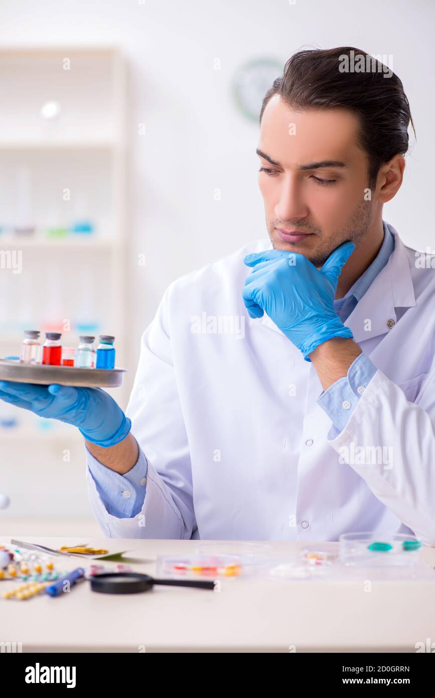 Young male lab assistant in the drug synthesis concept Stock Photo - Alamy