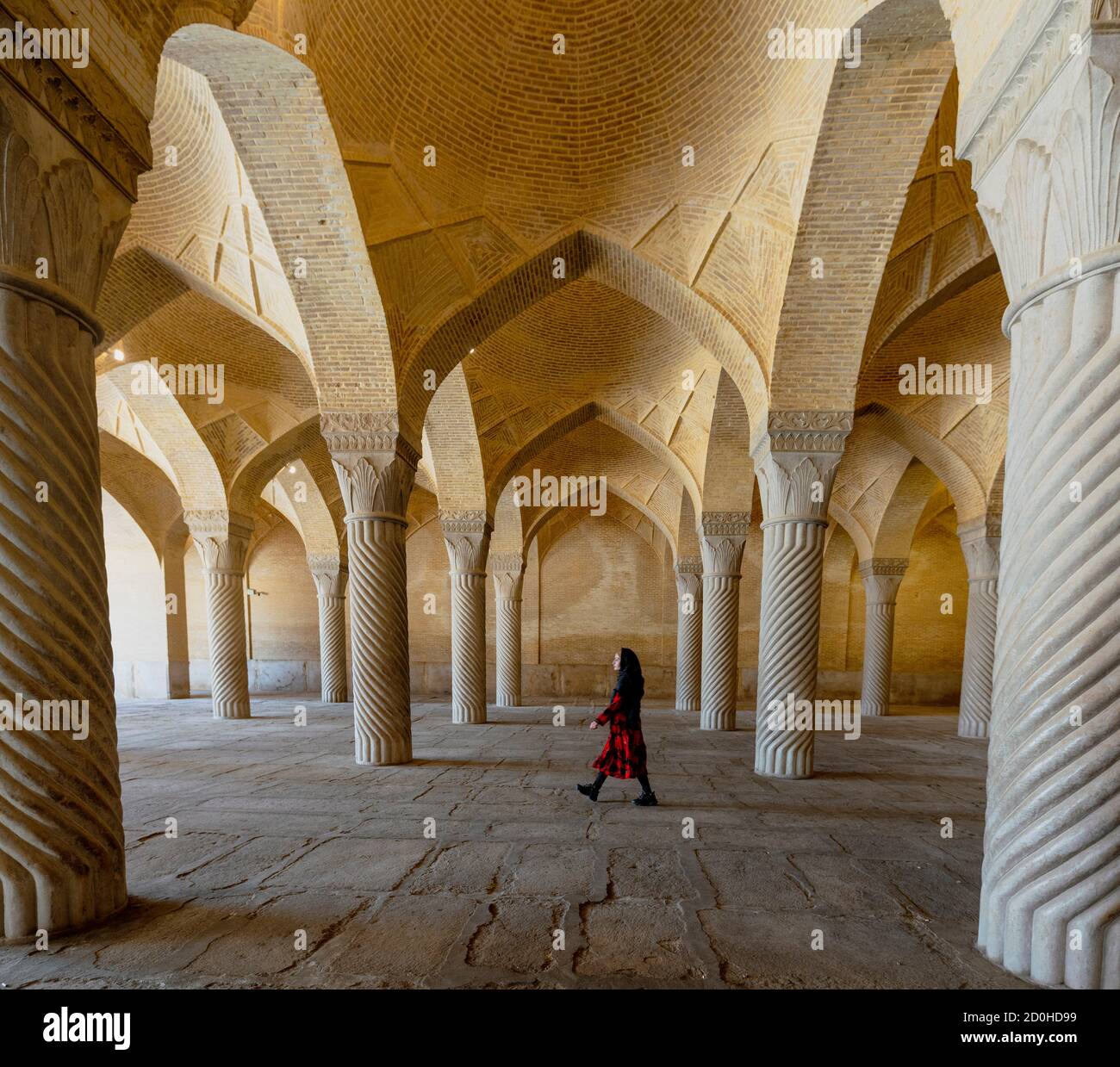Shiraz, Iran - 2019-04-08 - Woman walks through fluted columns of Vakil ...
