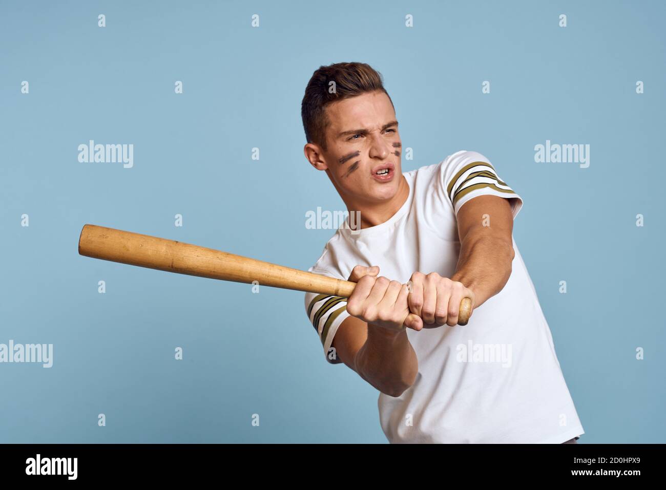 baseball guy with a bat in his hand on a blue background and a combat ...