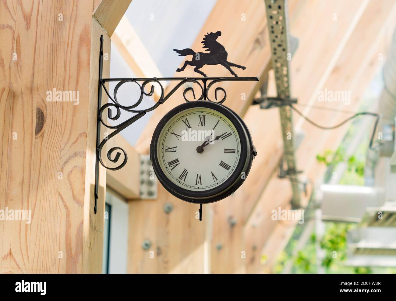 vintage black clock with porged horse on the wooden pole Stock Photo ...