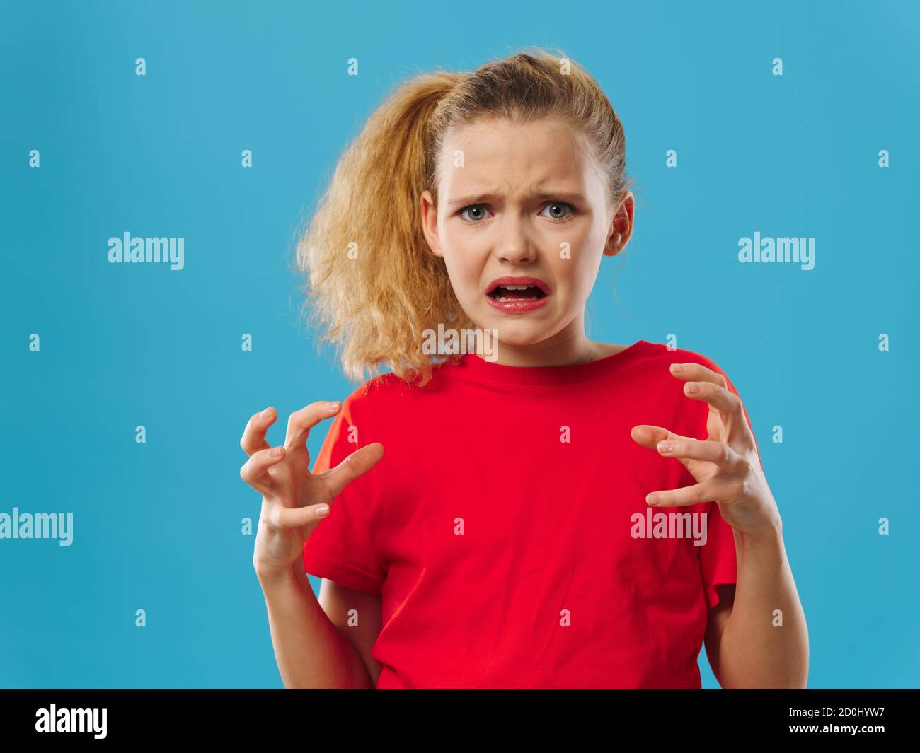 Girl holding hands in front of her disgruntled look red T-shirt ...