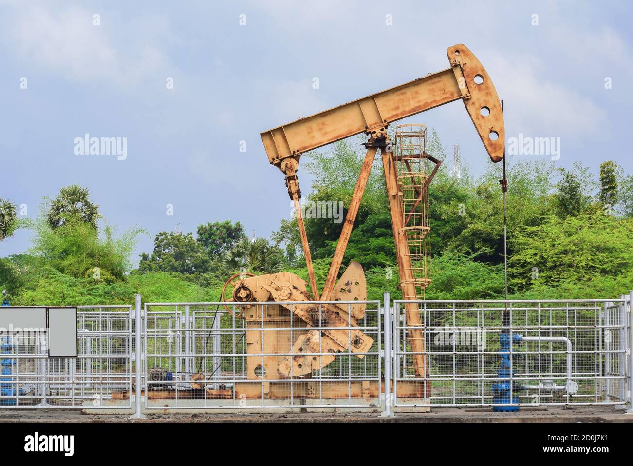 Old rusty isolated oil pump jack extracting crude oil and natural gas ...