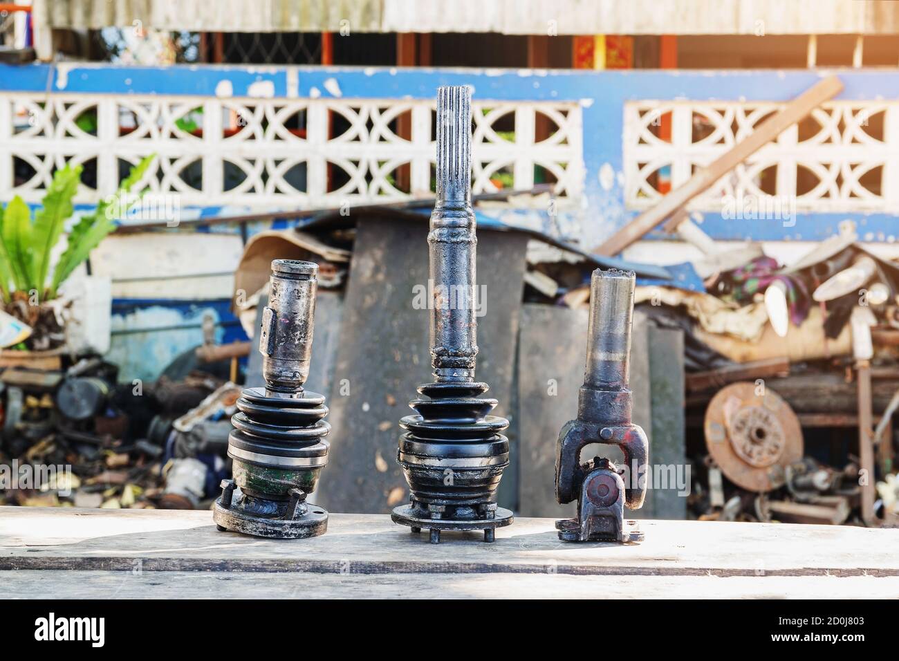 Front axle parts of 4 wheel drive pickup truck placed on the wooden ...