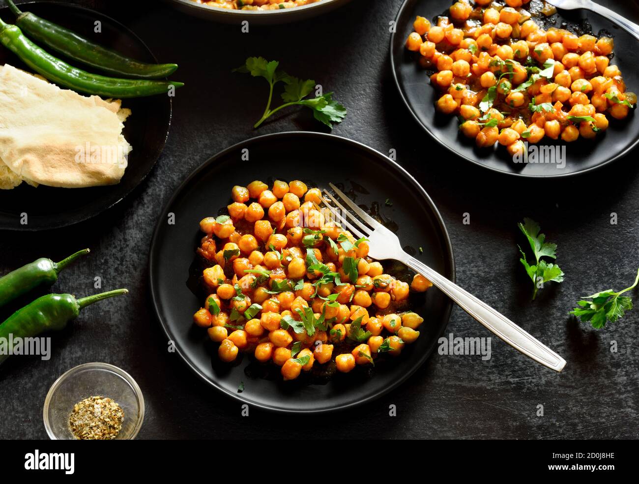 Indian style crispy roasted chickpeas on plate over black stone ...