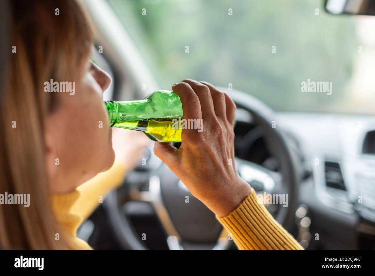 Woman drinking alcohol while driving Stock Photo - Alamy
