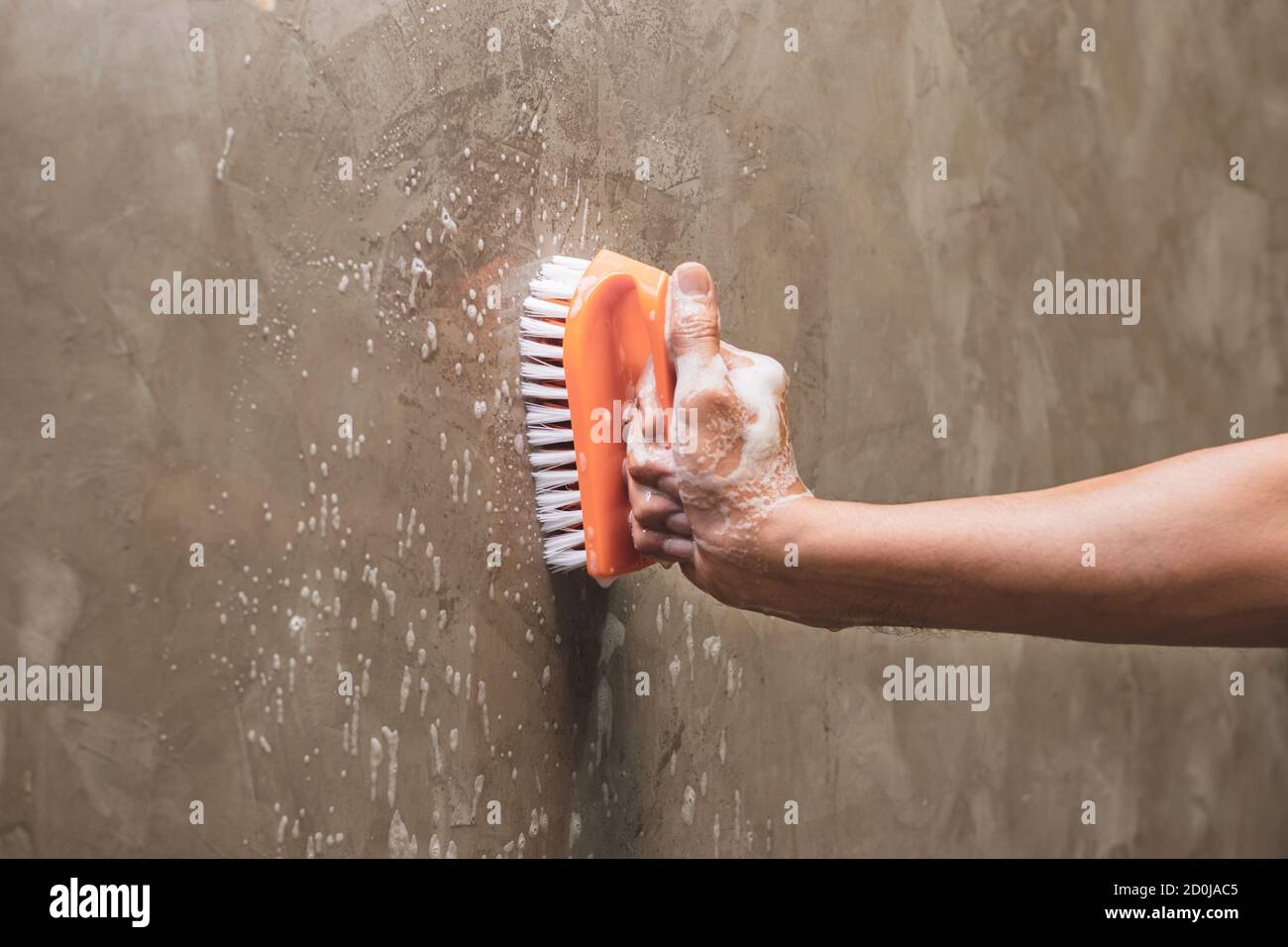 Men's hands are used to convert polishing cleaning on the concrete wall ...