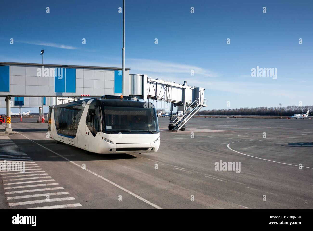 Bus at the airport apron near passenger boarding bridge Stock Photo - Alamy