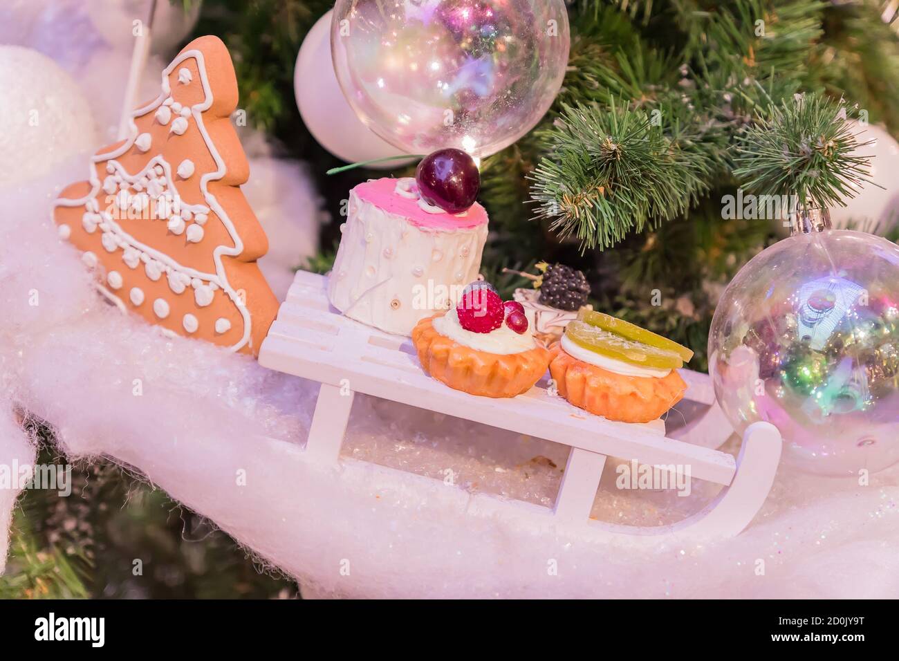 Close up of christmas tree decoration - toy sleighfull of sweets and ...