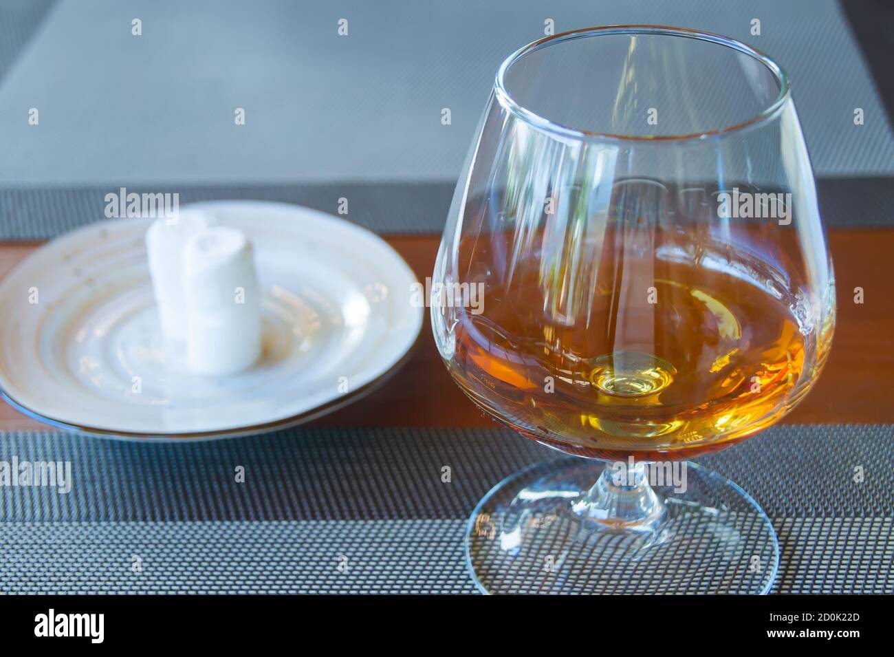 A glass of cognac on a table. At the restaurant or bar Stock Photo - Alamy