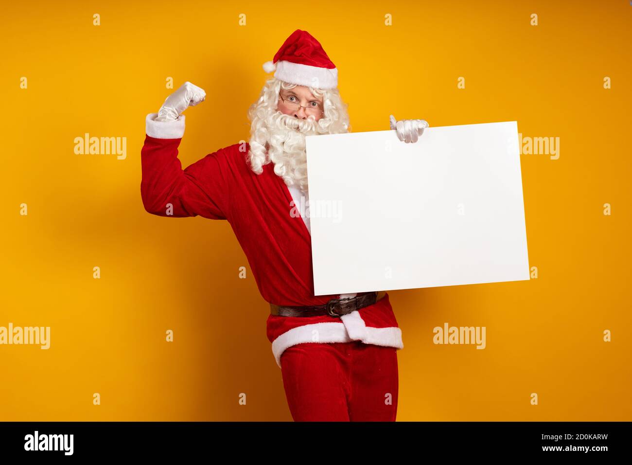 Male actor in a costume of Santa Claus holds in his hands a large white ...