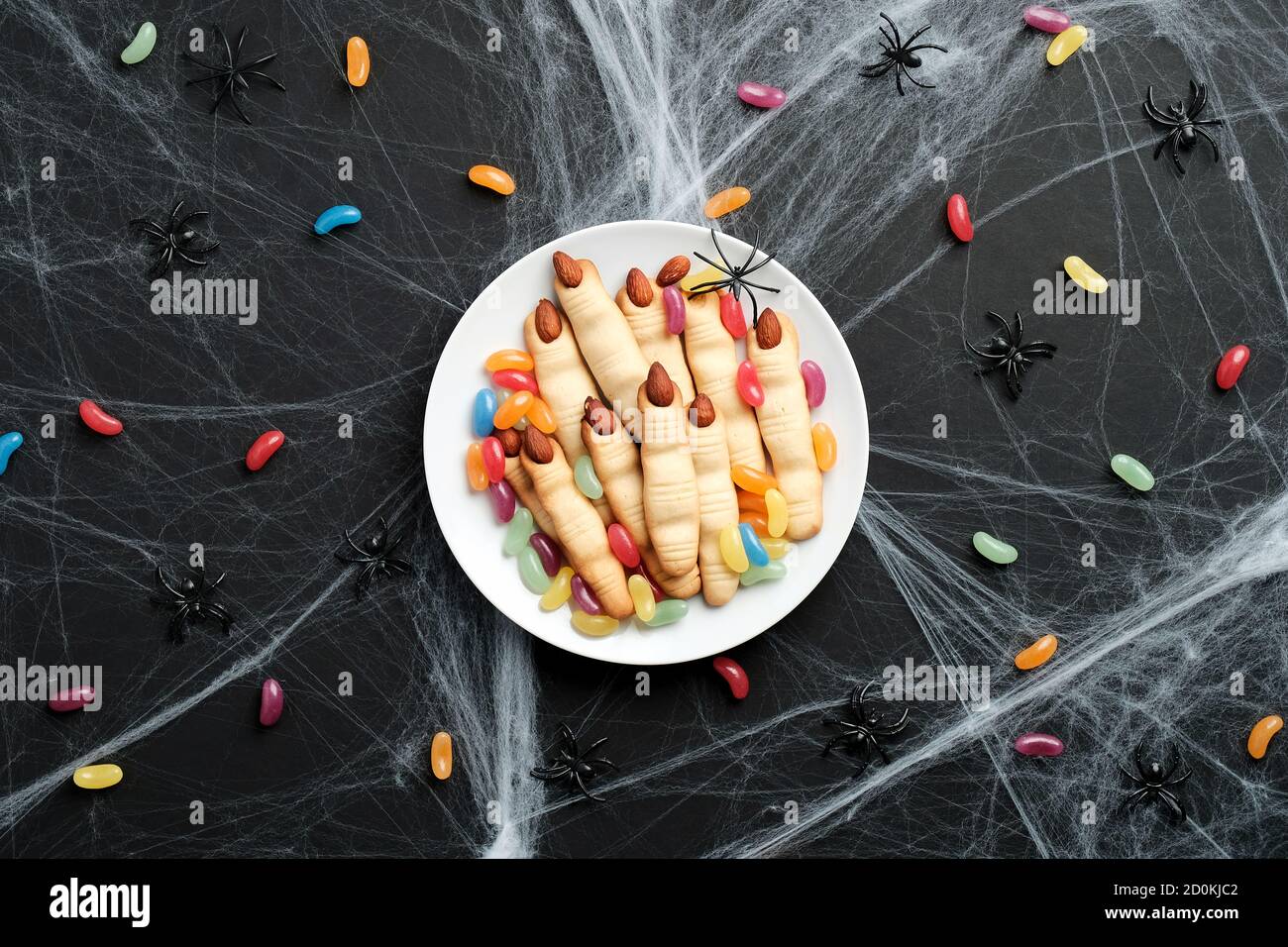 Halloween tasty cookies in form of witches fingers and colorful candies ...