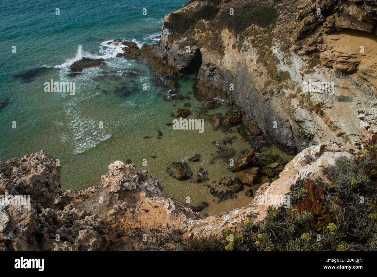 Small beach landscape standing in he middle of a cliff with turquoise ...