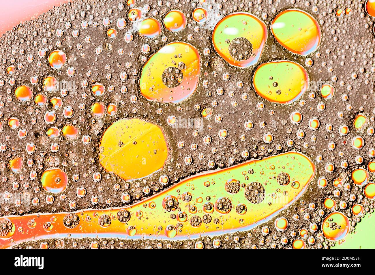 Oil drops on water surface lit from beneath Stock Photo - Alamy
