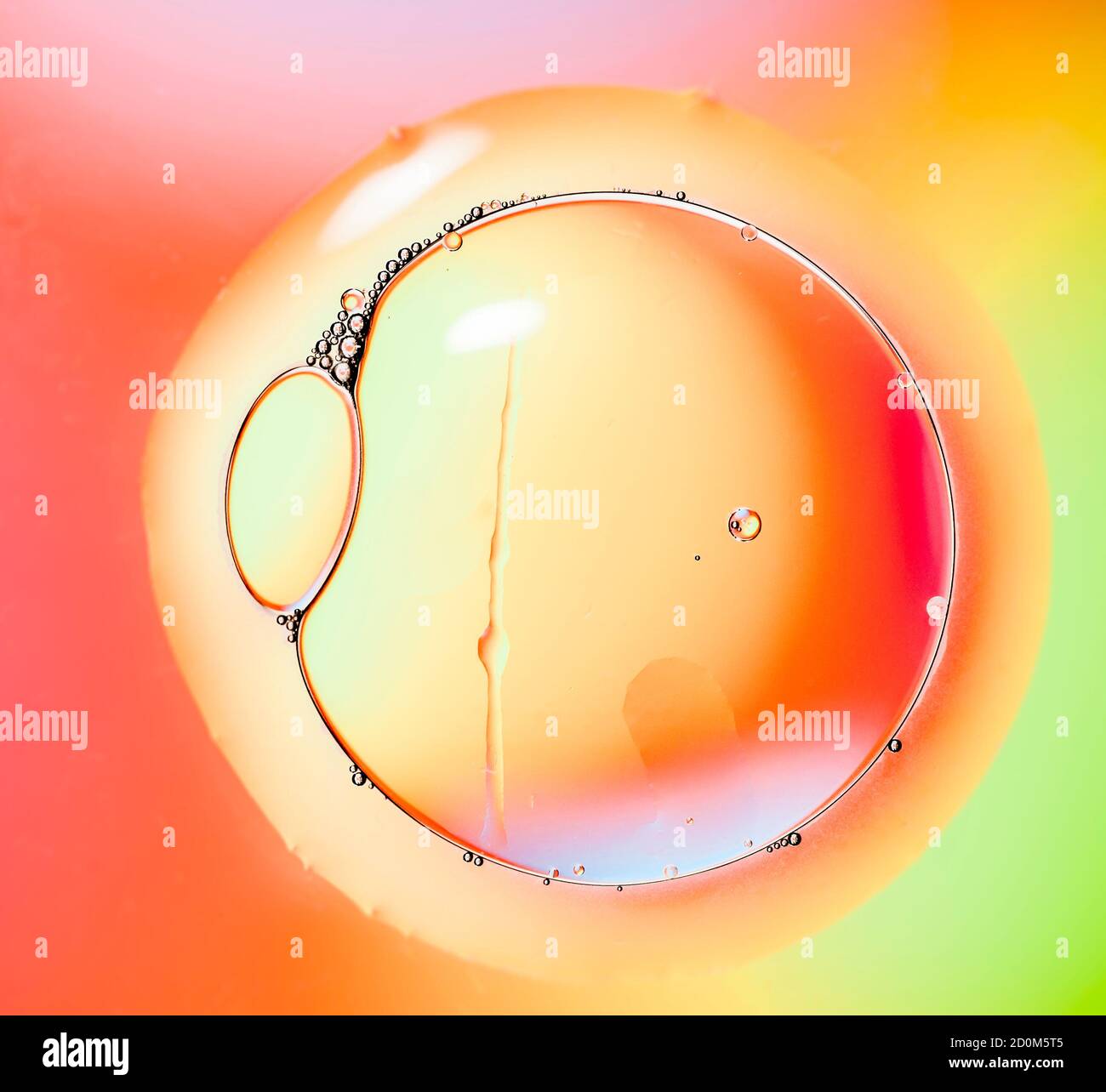 Oil drops on water surface lit from beneath Stock Photo - Alamy