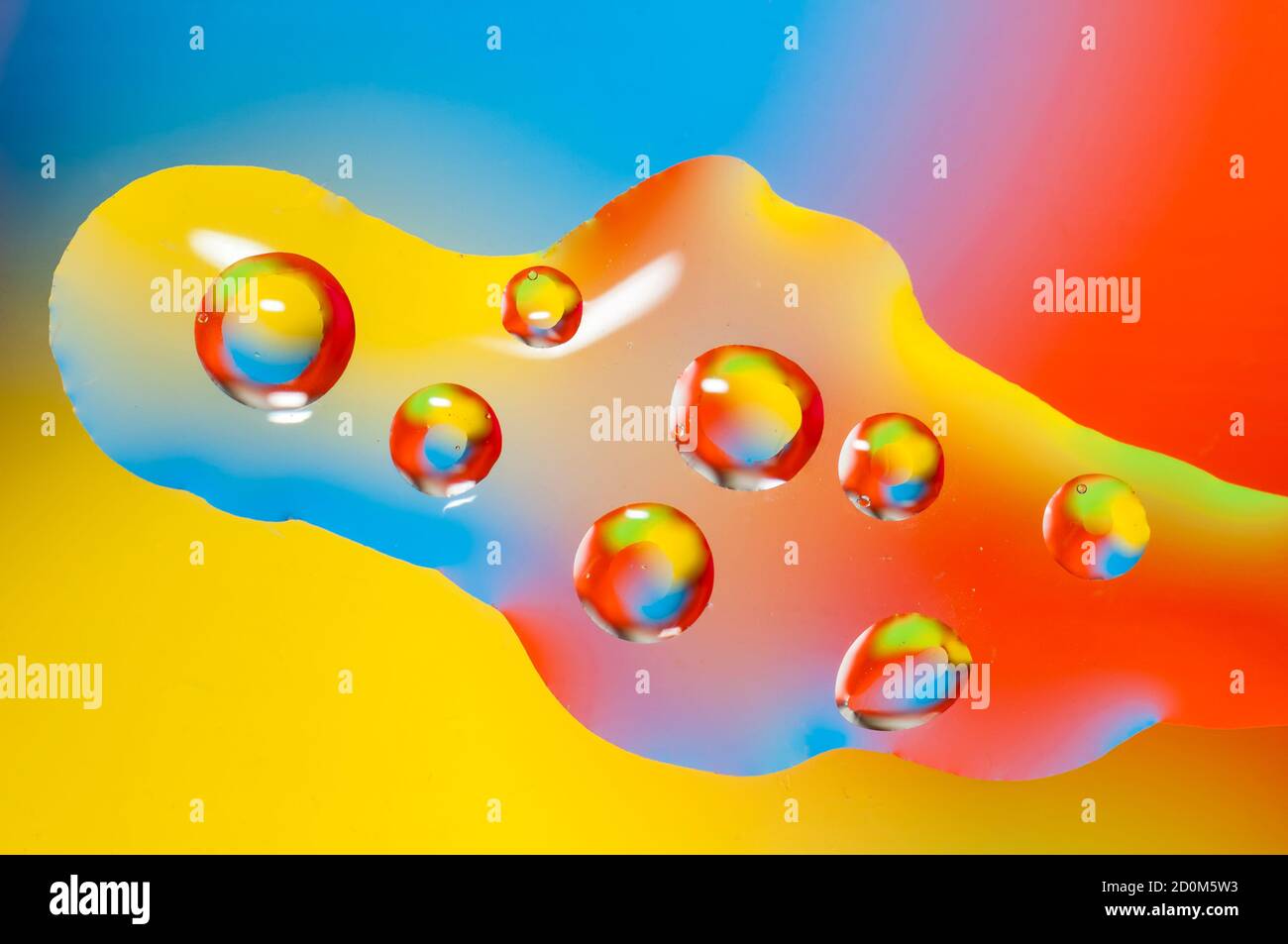 Oil drops on water surface lit from beneath Stock Photo - Alamy