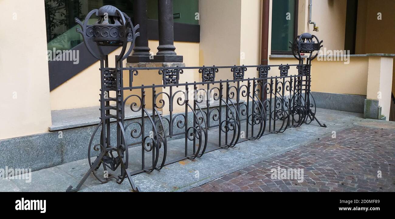 Wrought iron bicycle rack photographed in the historic center of Asti ...