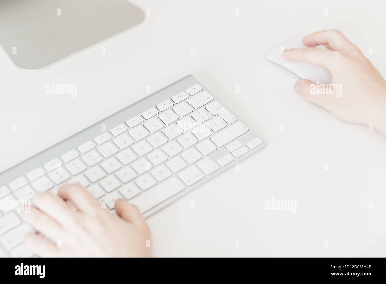 Closeup shot of women's hands using a wireless mouse and computer ...