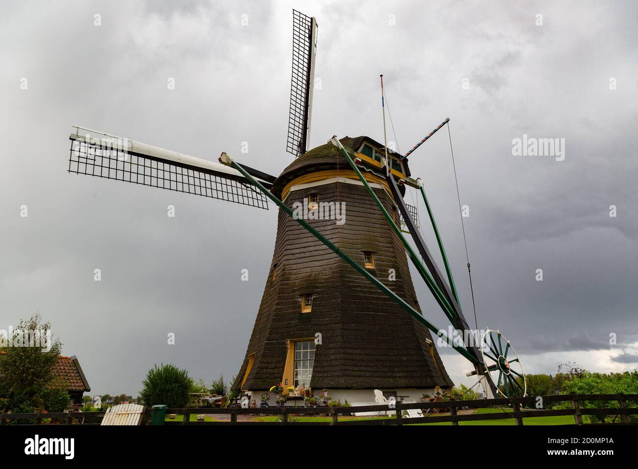 Ancient Dutch windmill under a dark cloudy sky Stock Photo - Alamy