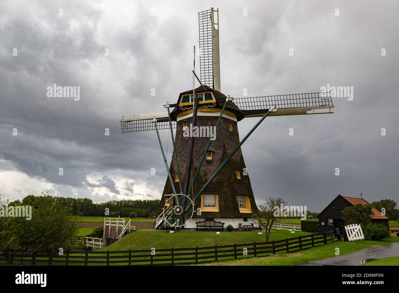 Ancient Dutch windmill under a dark cloudy sky Stock Photo - Alamy