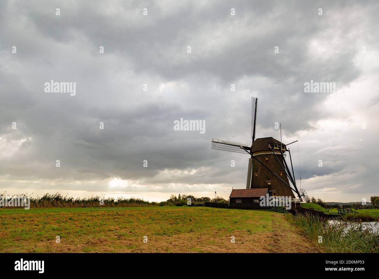 Ancient Dutch windmill under a dark cloudy sky Stock Photo - Alamy
