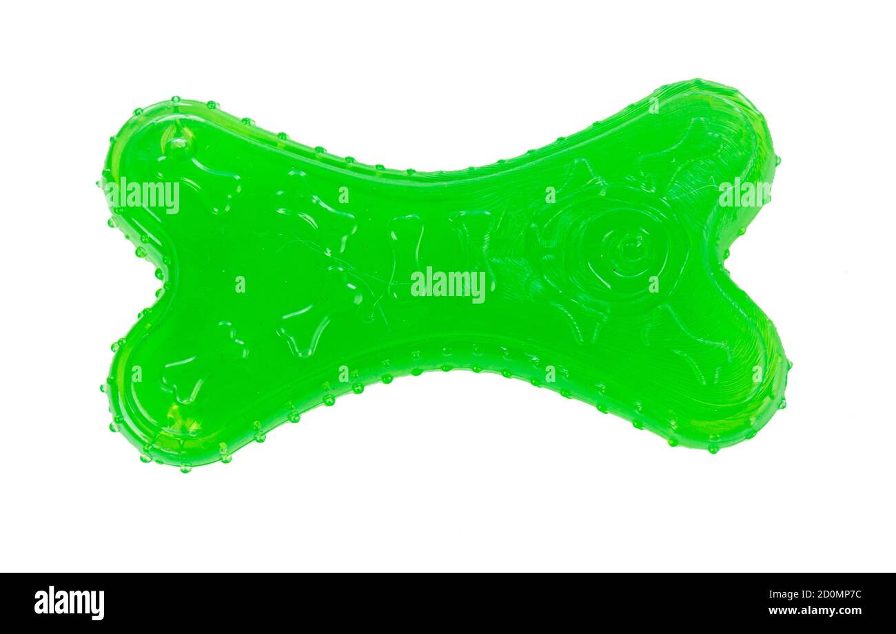 Green dog toy in the shape of a bone on a white background Stock Photo ...