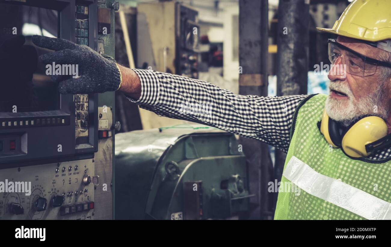 Smart factory worker using machine in factory workshop . Industry and ...
