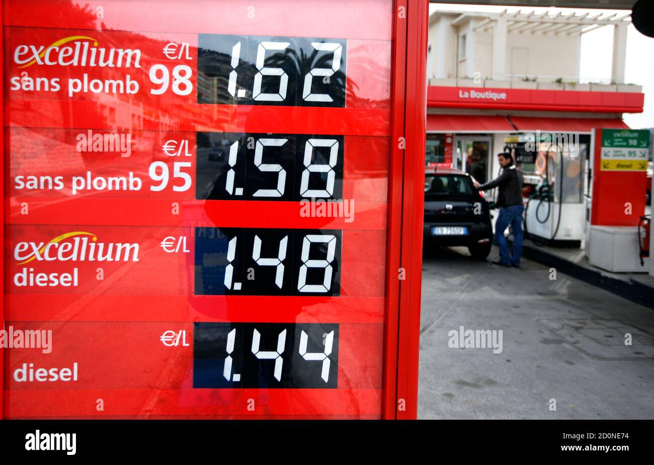 Customer fills her car with petrol at petrol station hi-res stock ...