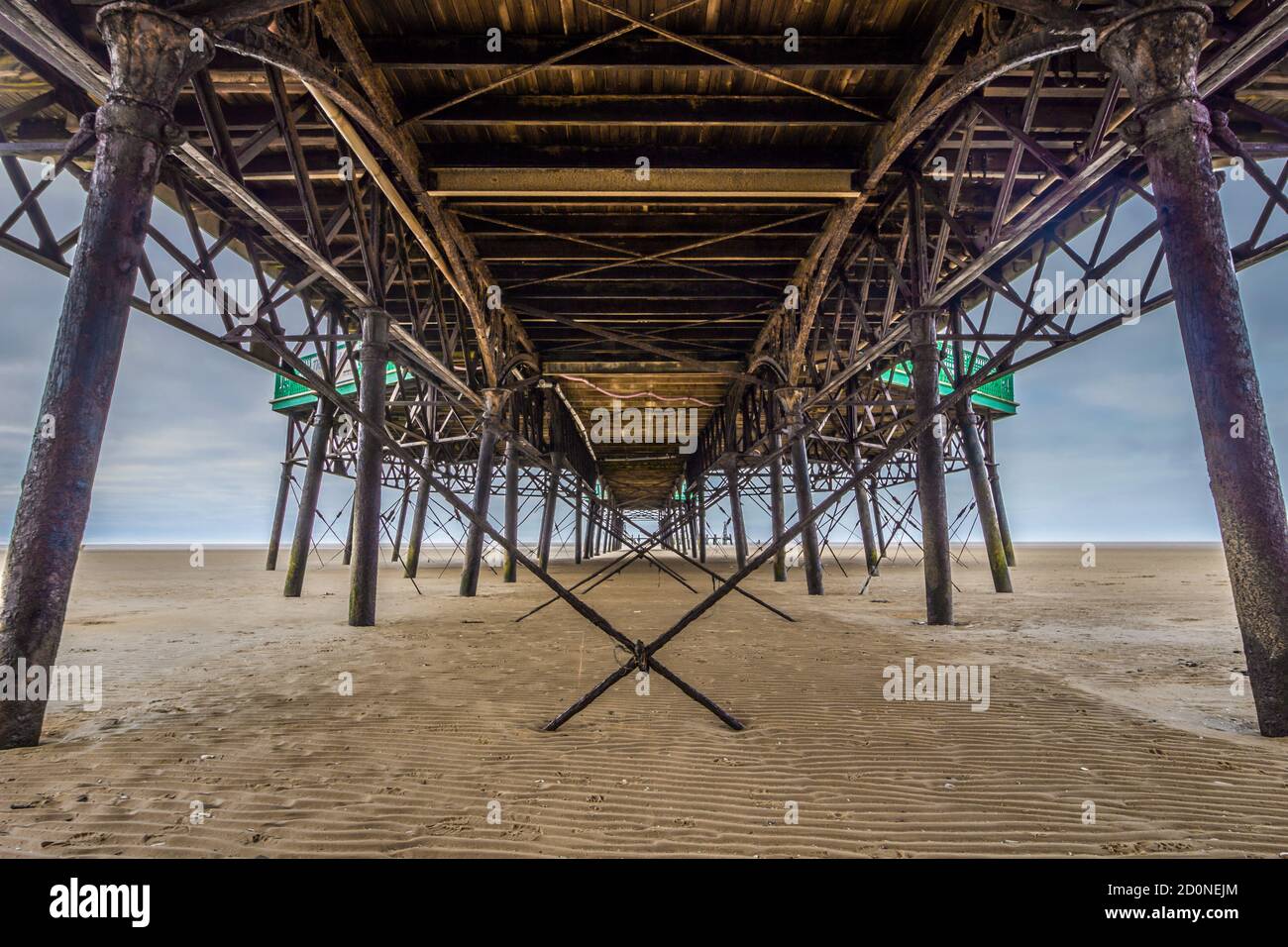 Beneath Lytham St Annes pier on the lancashire coast. Symmetry in the ...