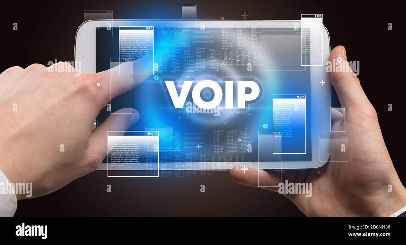 Close-up of a hand holding tablet with VOIP abbreviation, modern ...