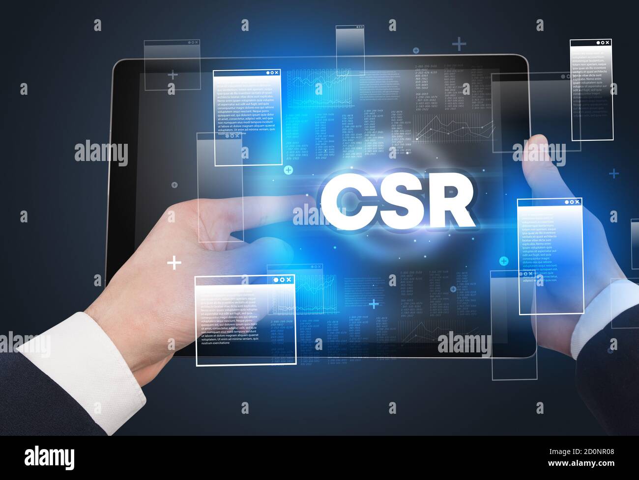 Close-up of a hand holding tablet with CSR abbreviation, modern ...